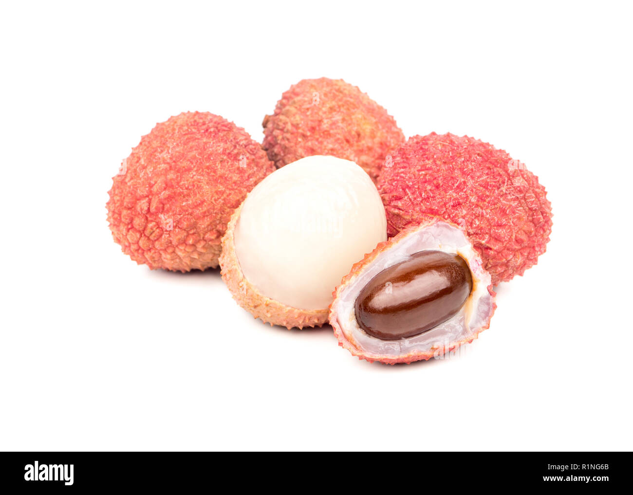 Several lychee fruits in a shell with halves on a white background ...