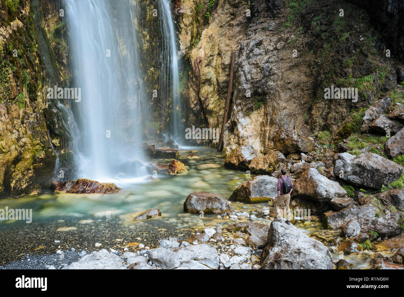 Man looking up at Theth Waterfall, Theth, The Accursed Mountains ...