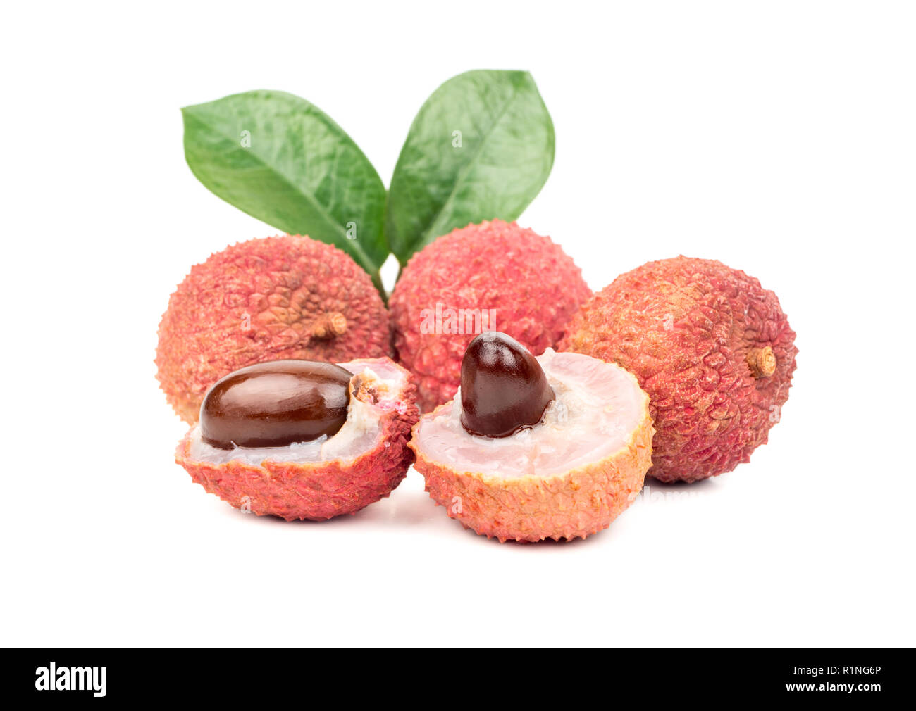 Chinese lychee fruit with two halves and leaves on a white background ...