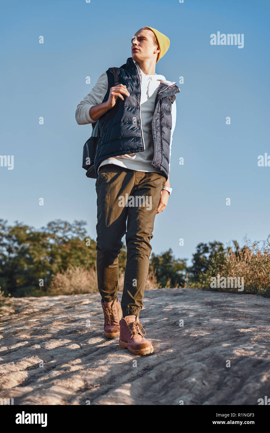 Young tourist blogger is walking around mountain road, close-up photo ...