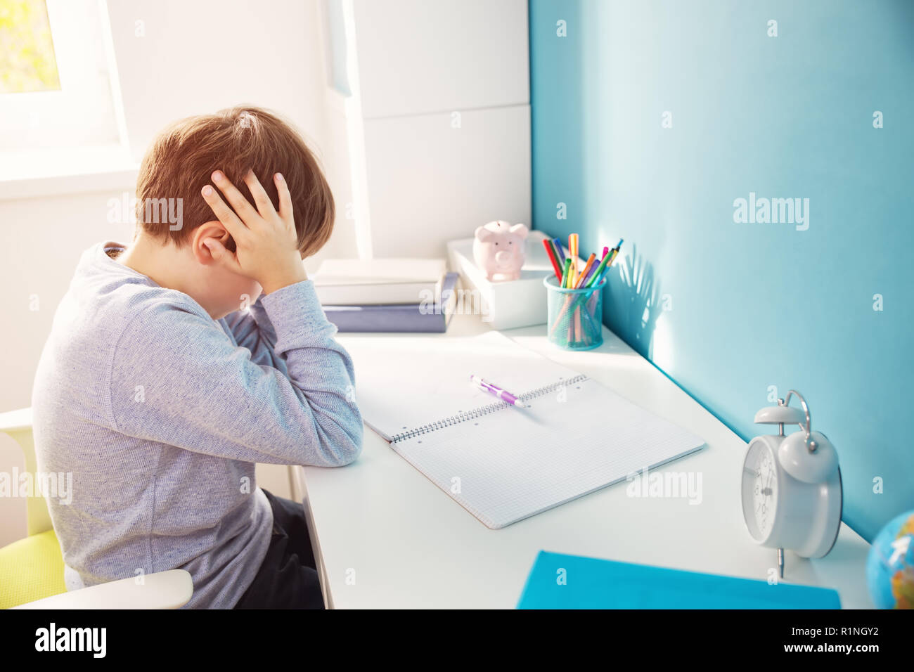 Child writing with pencil hi-res stock photography and images - Alamy