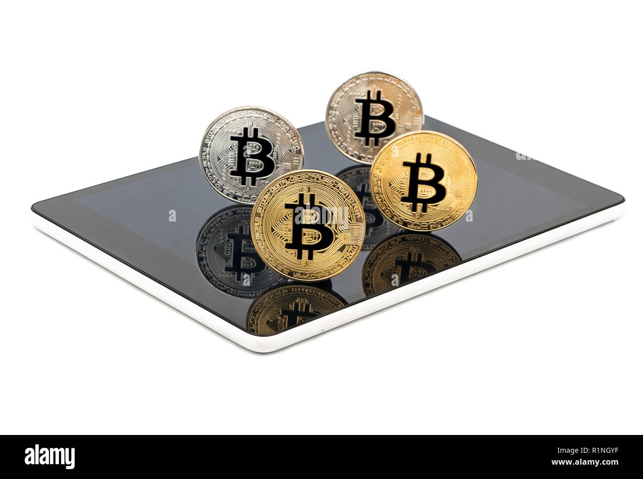 Gold and silver bitcoin coin on tablet close up Stock Photo - Alamy