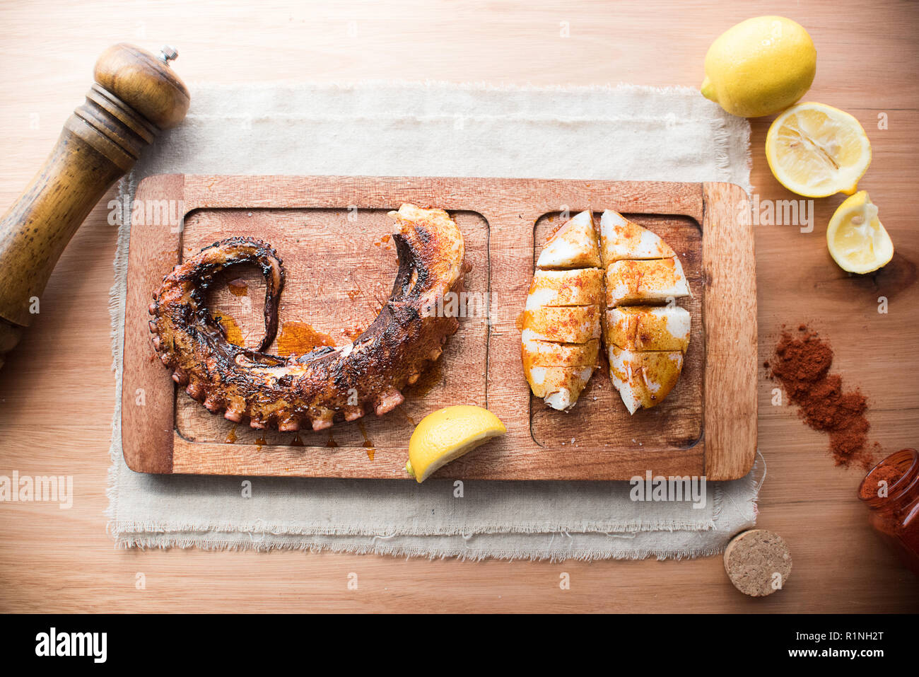 Octopus and potatoes dish with lemon Stock Photo - Alamy