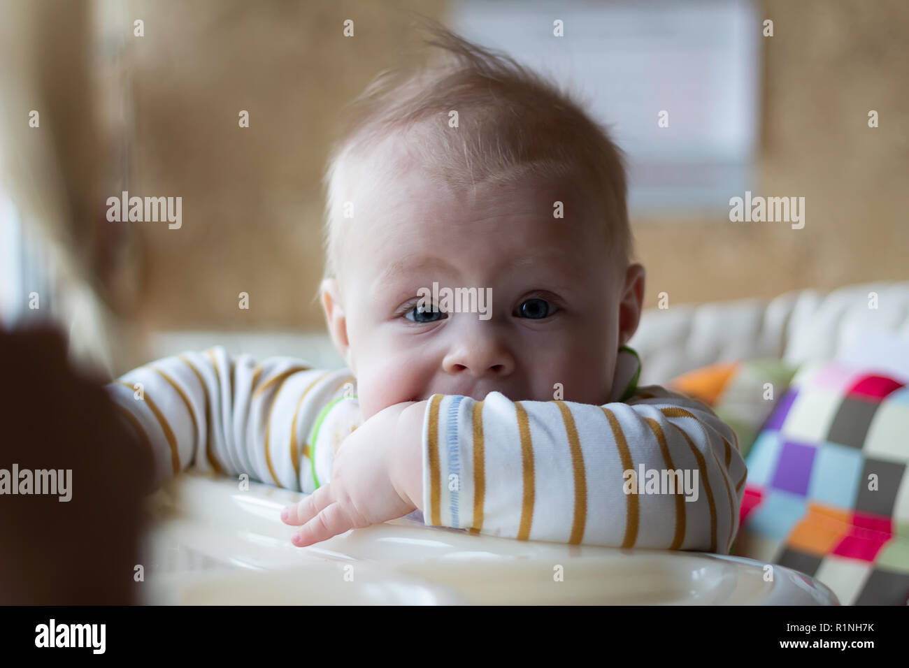 The first feeding of the baby from the spoon. Mom feeds baby ...
