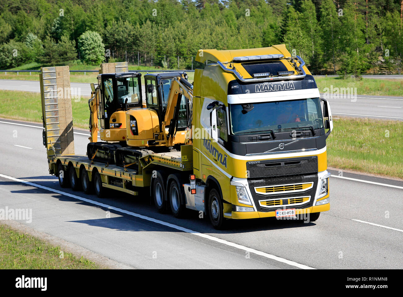 Paimio, Finland - June 1, 2018: Yellow Volvo FH truck hauls two Cat 305 ...