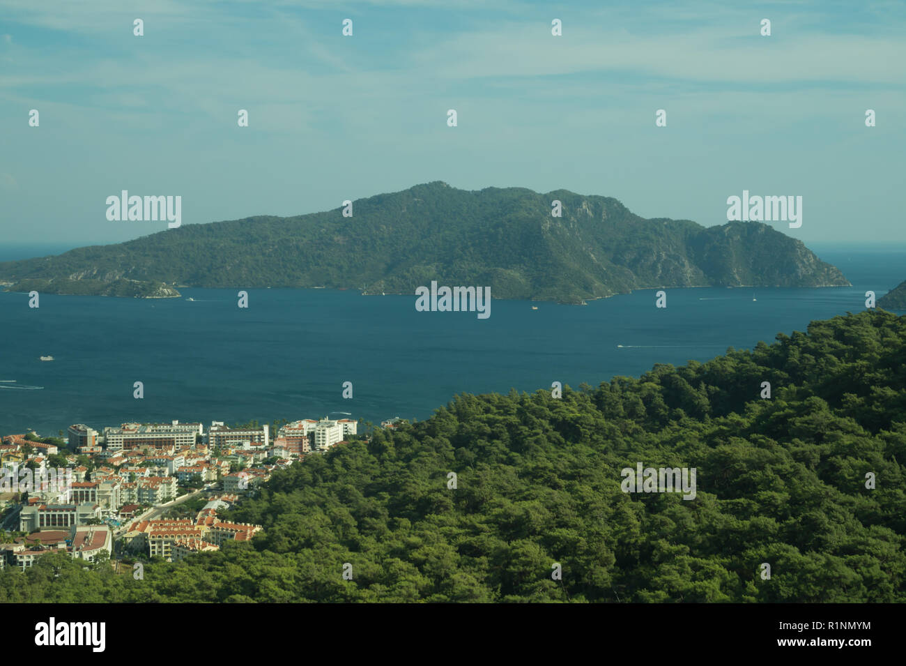 Nature landscape with a city by the shore of the sea between the hills ...