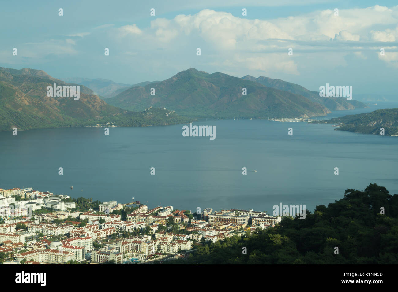 Nature landscape with a city by the shore of the sea between the hills ...