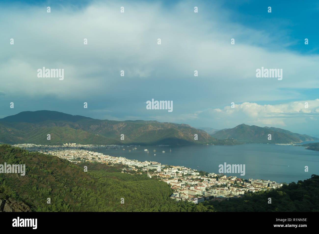 Nature landscape with a city by the shore of the sea between the hills ...