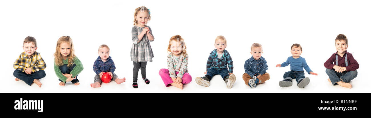 A Group of child and baby sitting on white studio background Stock ...