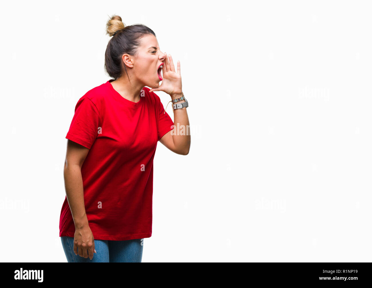 Young beautiful woman over isolated background shouting and screaming ...