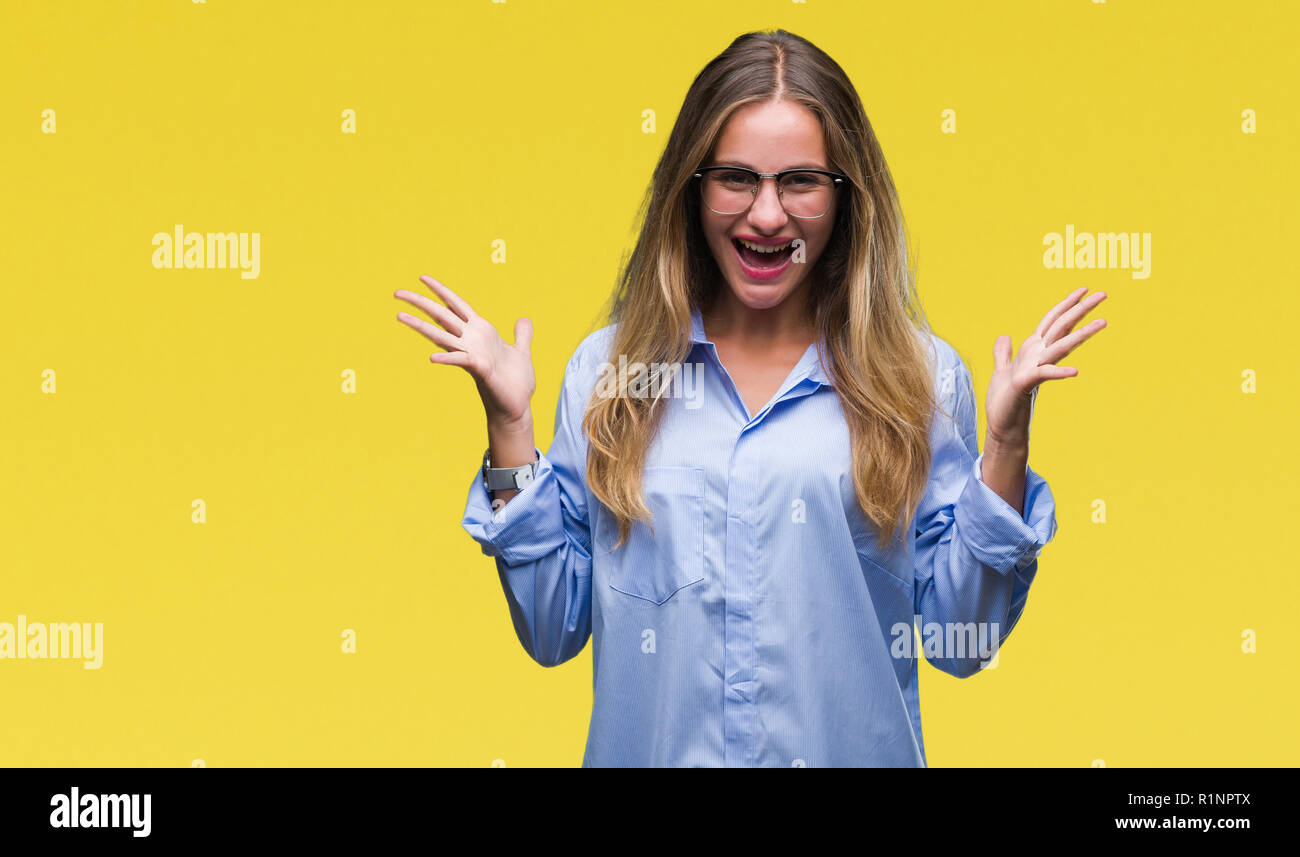 Young beautiful blonde business woman wearing glasses over isolated ...