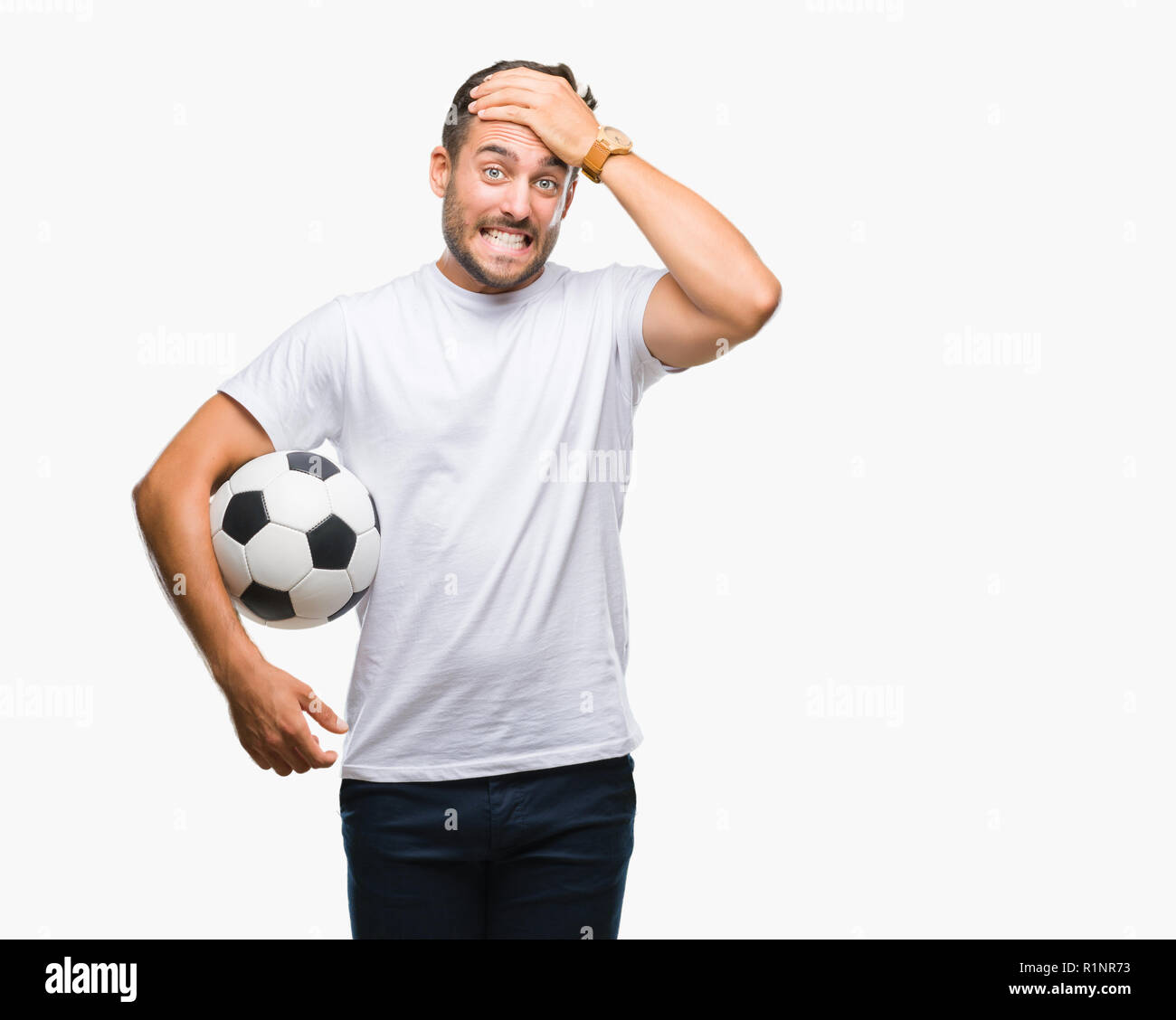Young handsome man holding soccer football ball over isolated ...