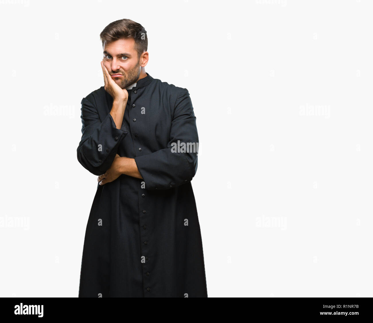 Young catholic christian priest man over isolated background thinking ...