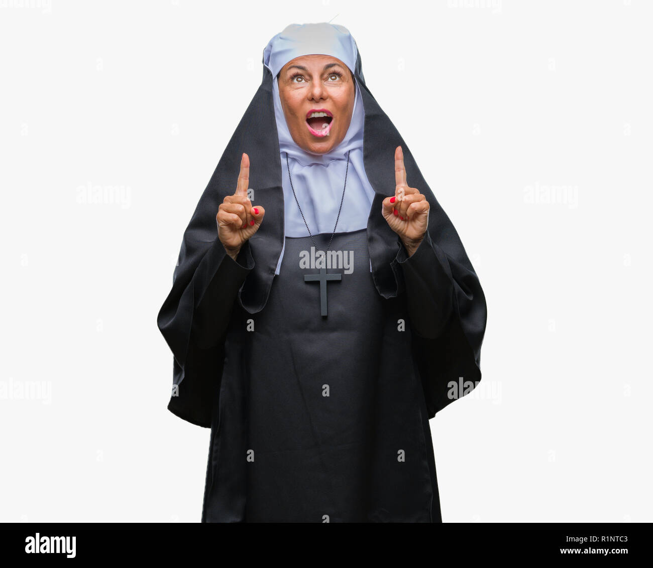 Middle age senior christian catholic nun woman over isolated background ...