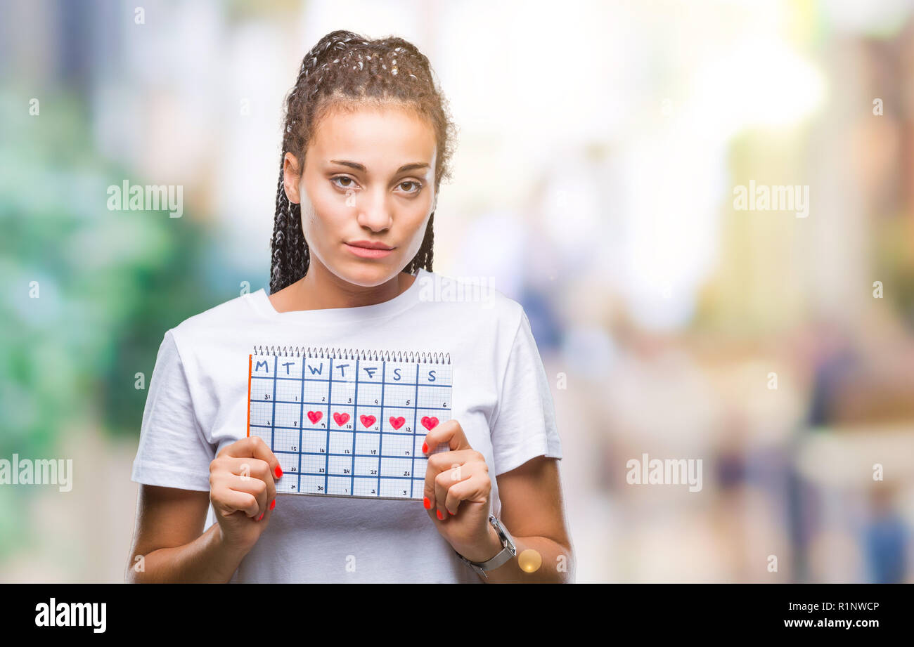 Young braided hair african american girl holding menstruation calendar ...