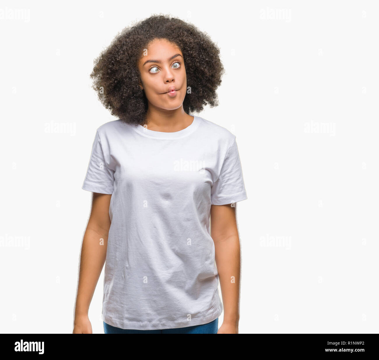Young afro american woman over isolated background making fish face ...