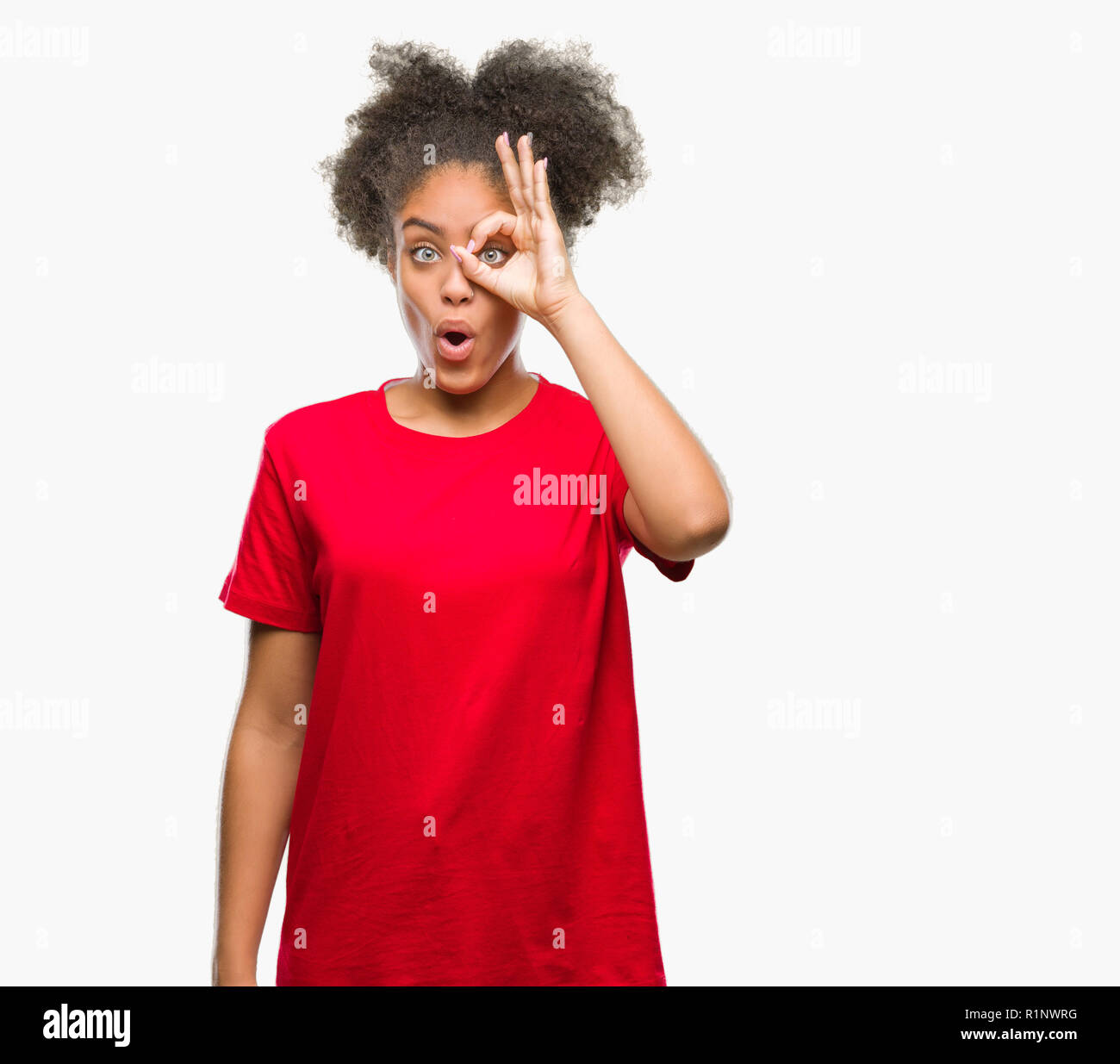 Young afro american woman over isolated background doing ok gesture ...
