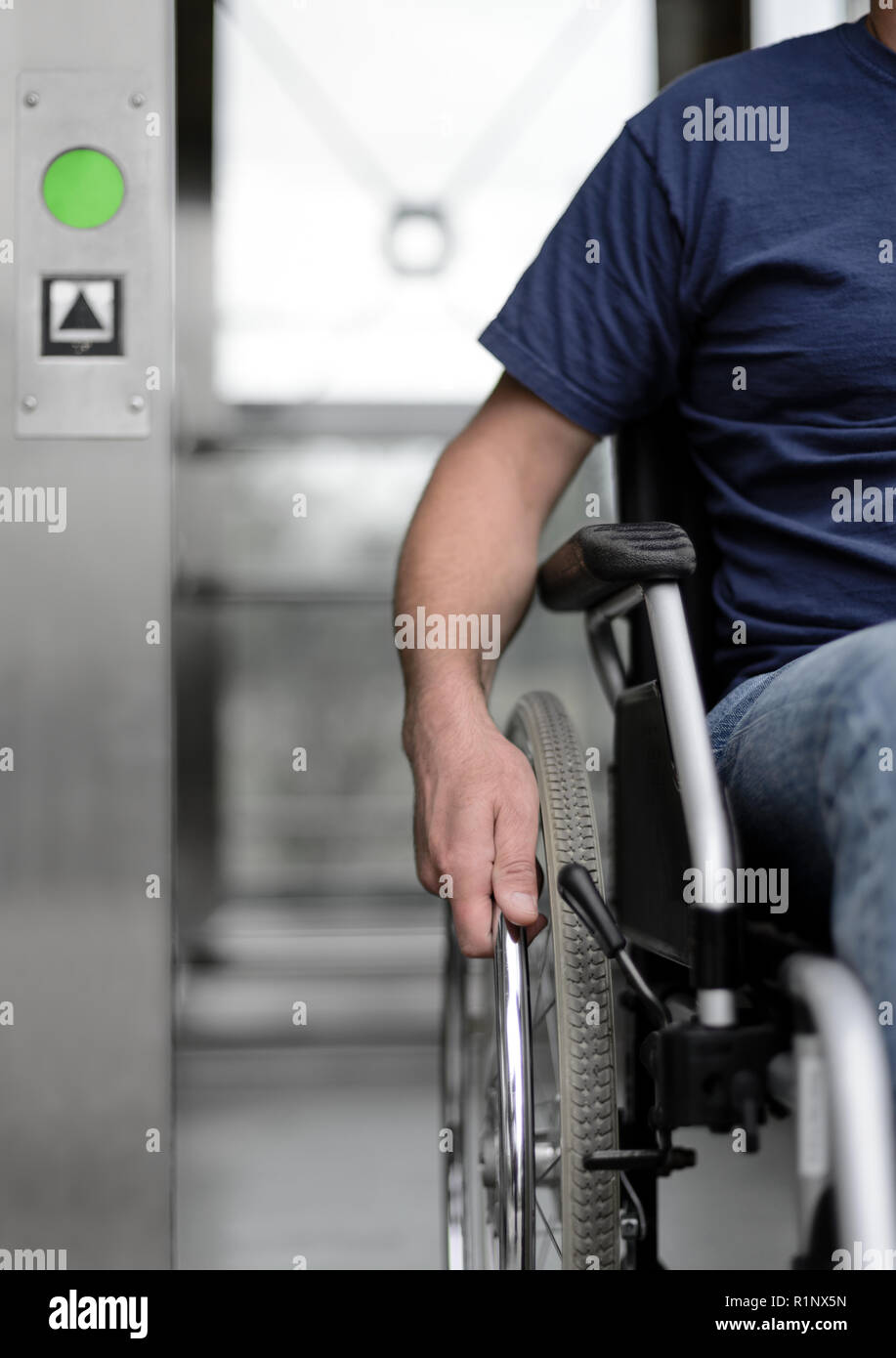 Wheelchair user uses barrier free accessible lift elevator enry Stock ...