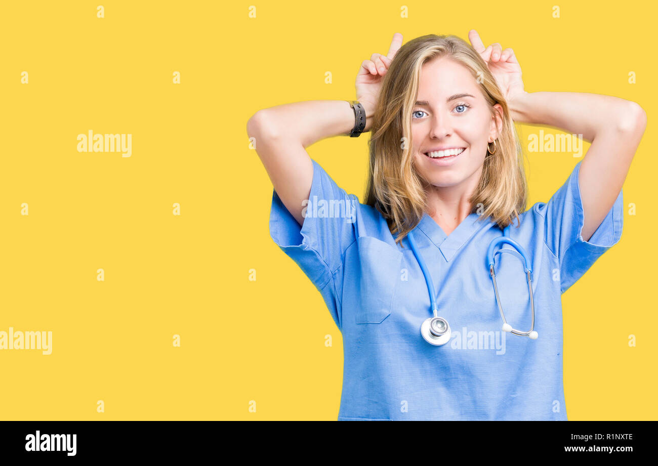Beautiful young doctor woman wearing medical uniform over isolated ...