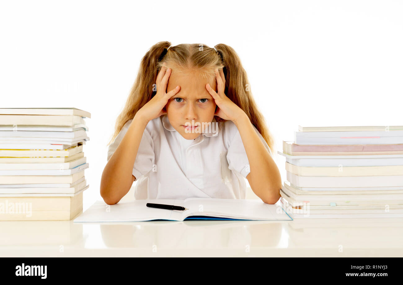 Sad and tired cute schoolgirl with blond hair sitting in stress doing ...