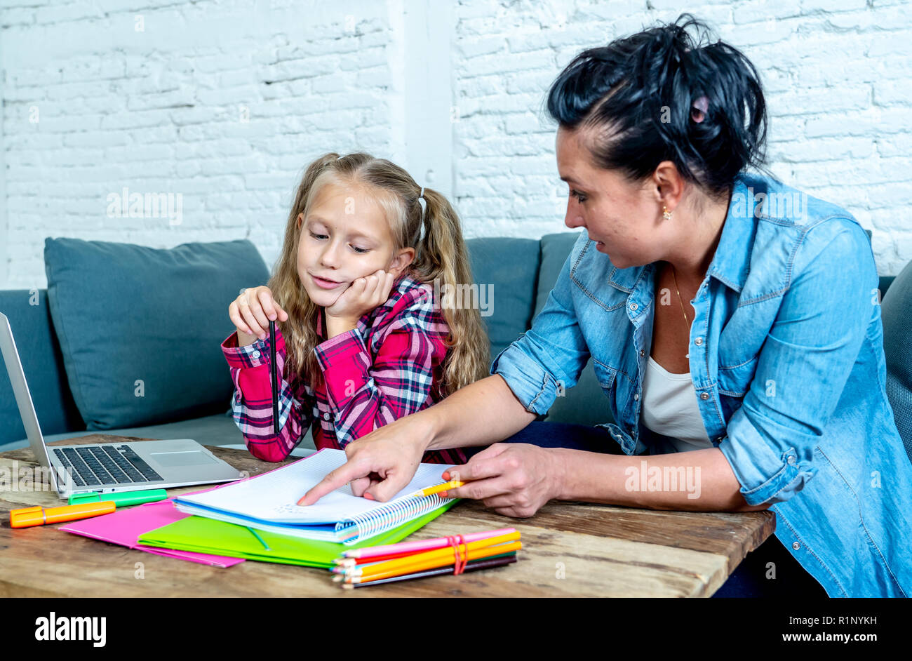 Mother becoming frustrated with daughter whilst doing homework sitting ...