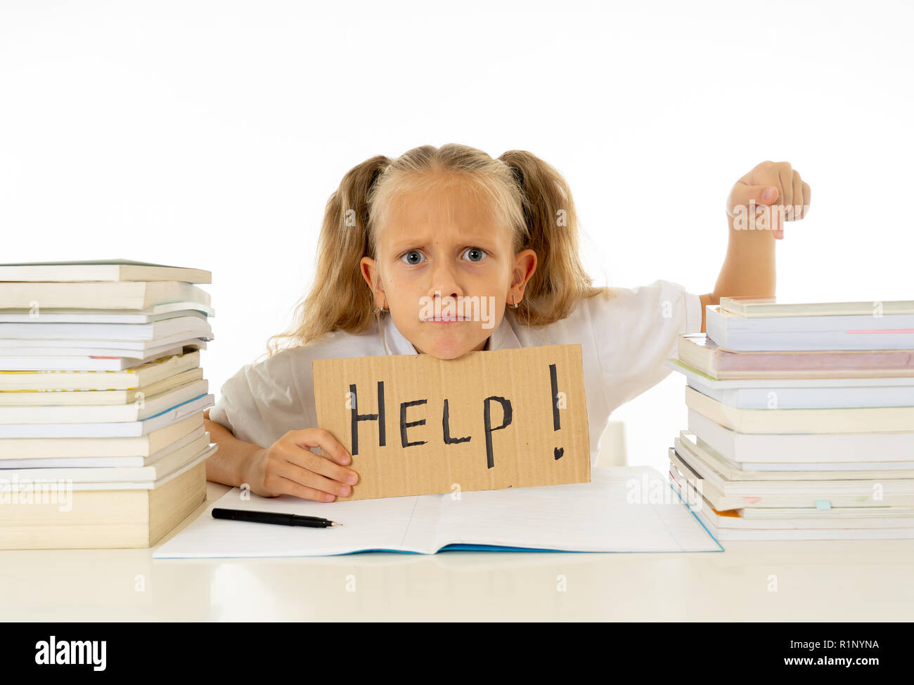 Sad tired and angry blonde school girl holding help sign in stress ...