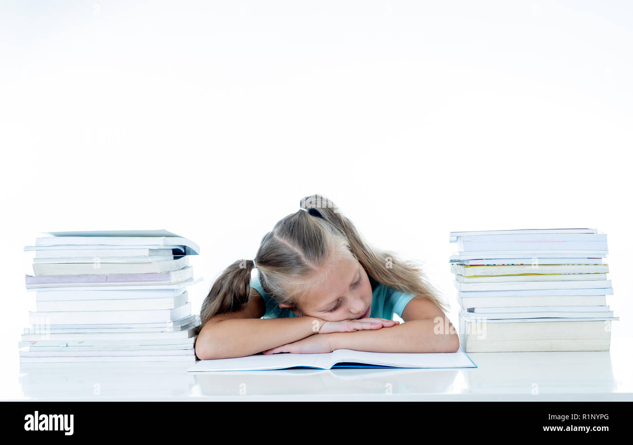 Exhausted sweet cute blonde girl sleeping on a pile of schoolbooks ...