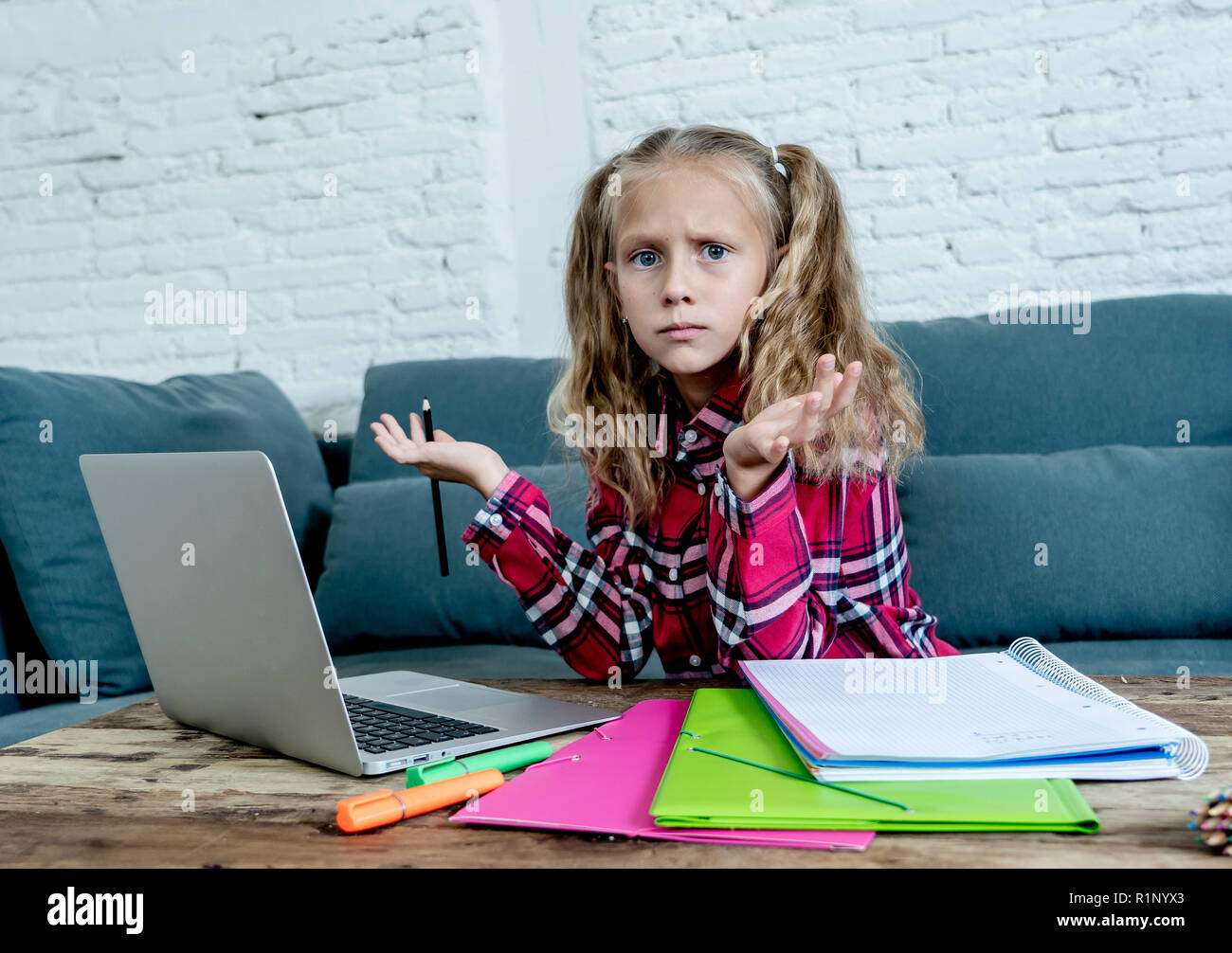 Cute elementary student feeling sad and confusing while doing difficult ...