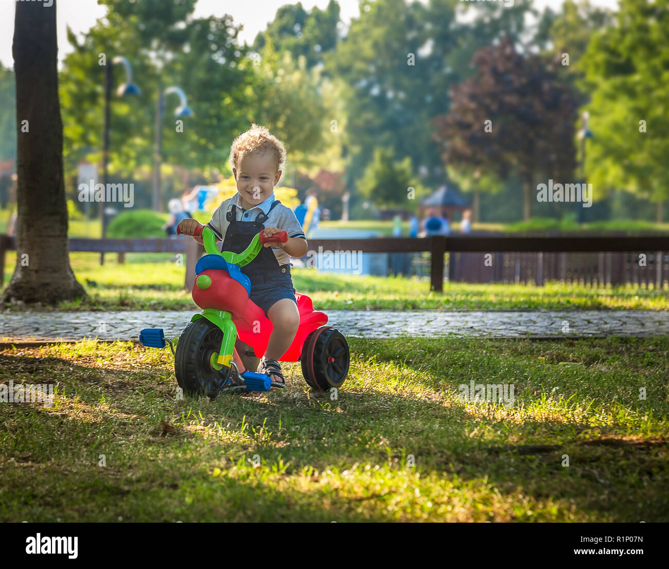 Smiling children baby boy riding bicycle outdoor Stock Photo - Alamy