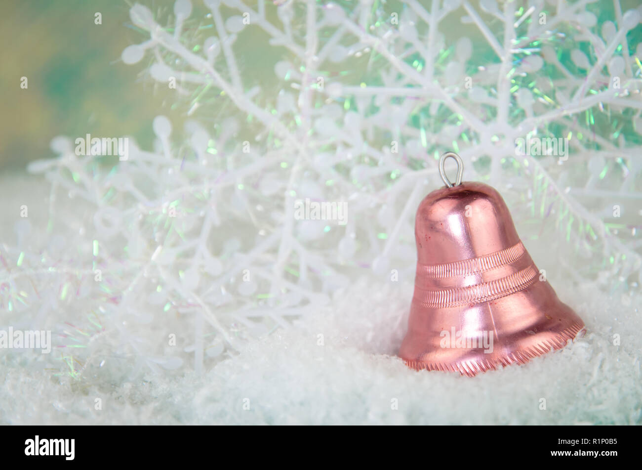 simple white snowflake and pink bell decoration in snowy background ...