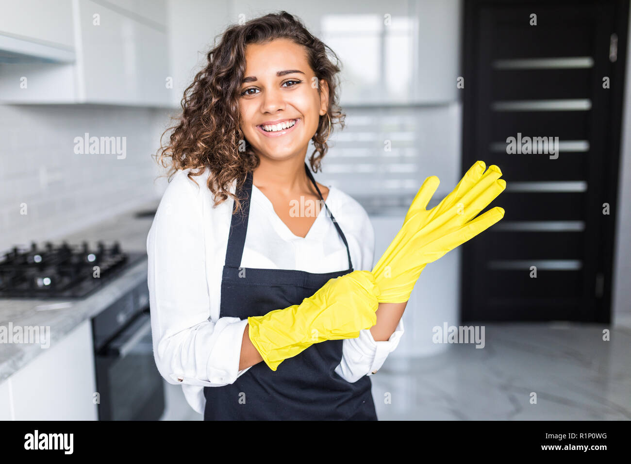 Portrait Of Young Attractive Caucasian Brunette Housewife At Kitchen