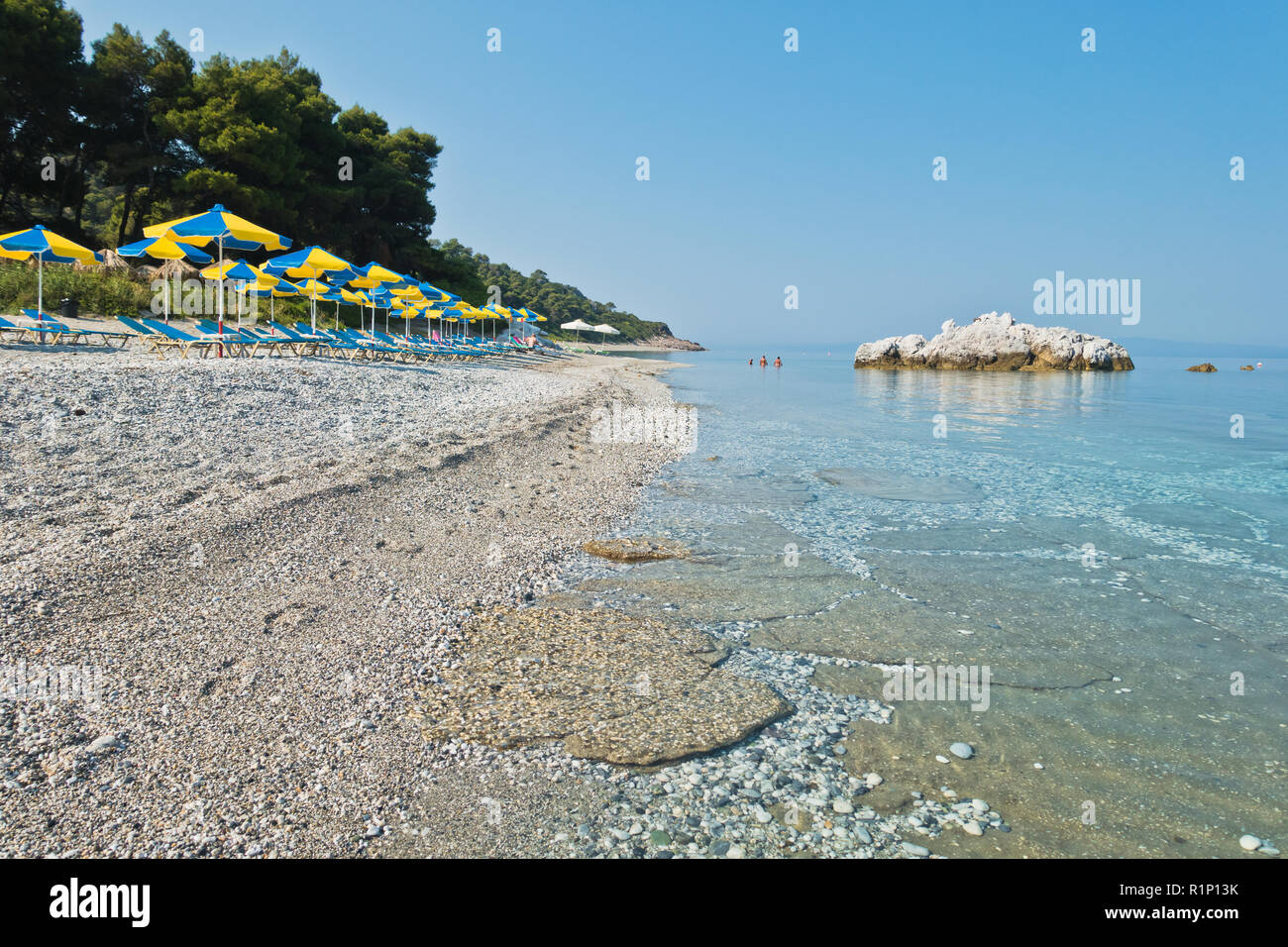 Sea rocks at calm and crystal clear turquoise water at morning, Milia ...