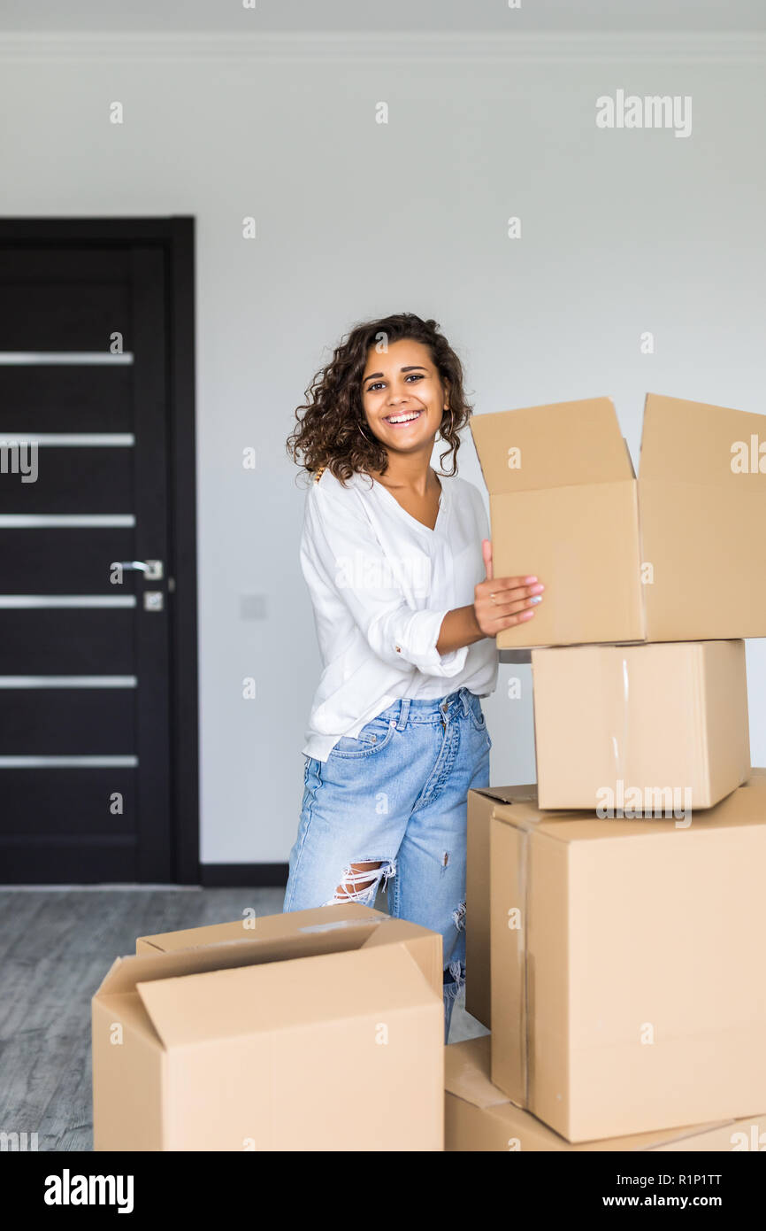 Happy smiling woman carrying carton boxes moving Stock Photo - Alamy