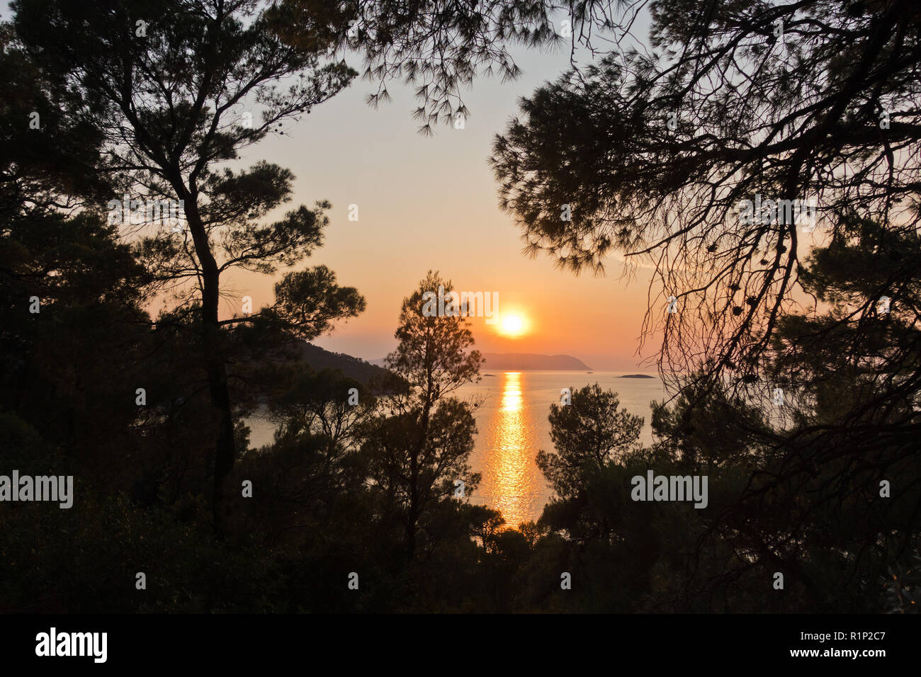 Sunset behind Skiathos island, a view from the road above Kastani beach ...