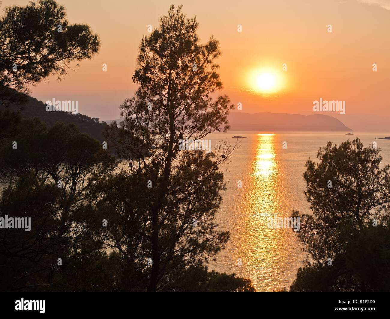 Sunset behind Skiathos island, a view from the road above Kastani beach ...