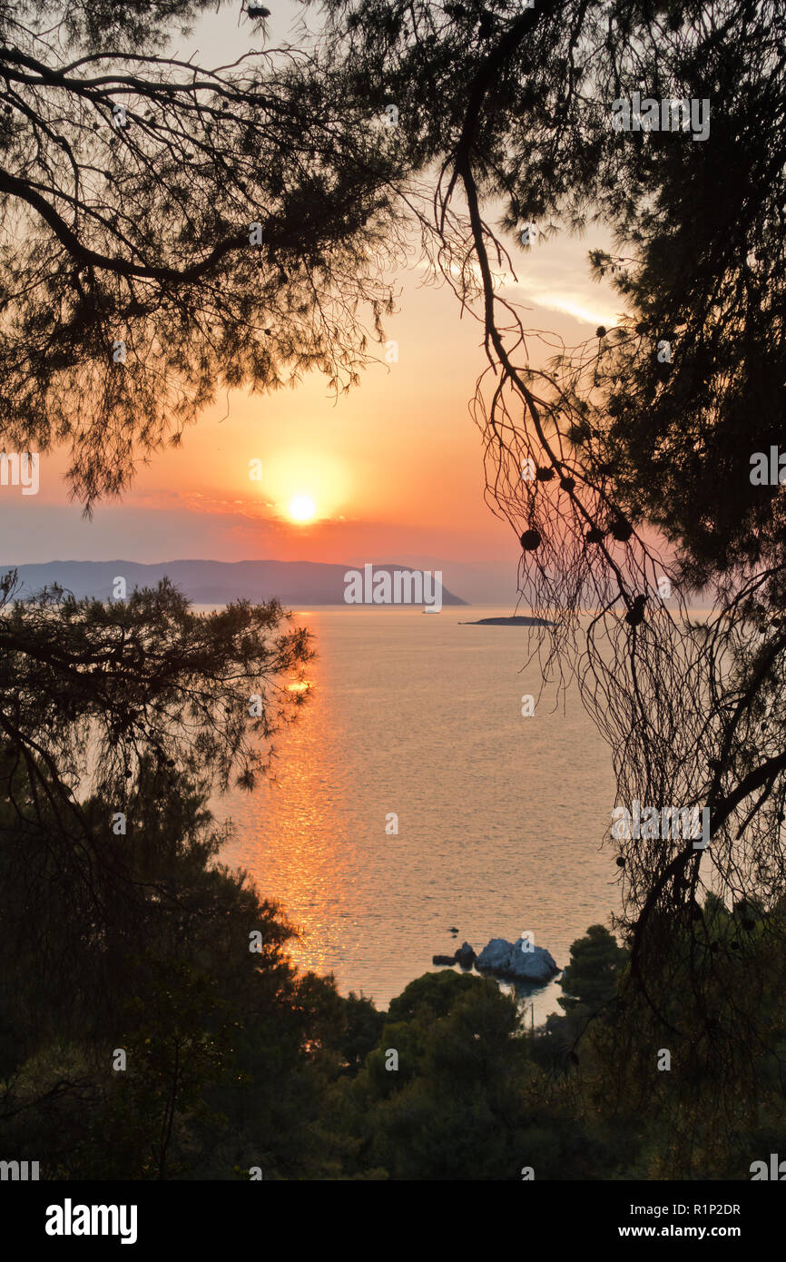Sunset behind Skiathos island, a view from the road above Kastani beach ...