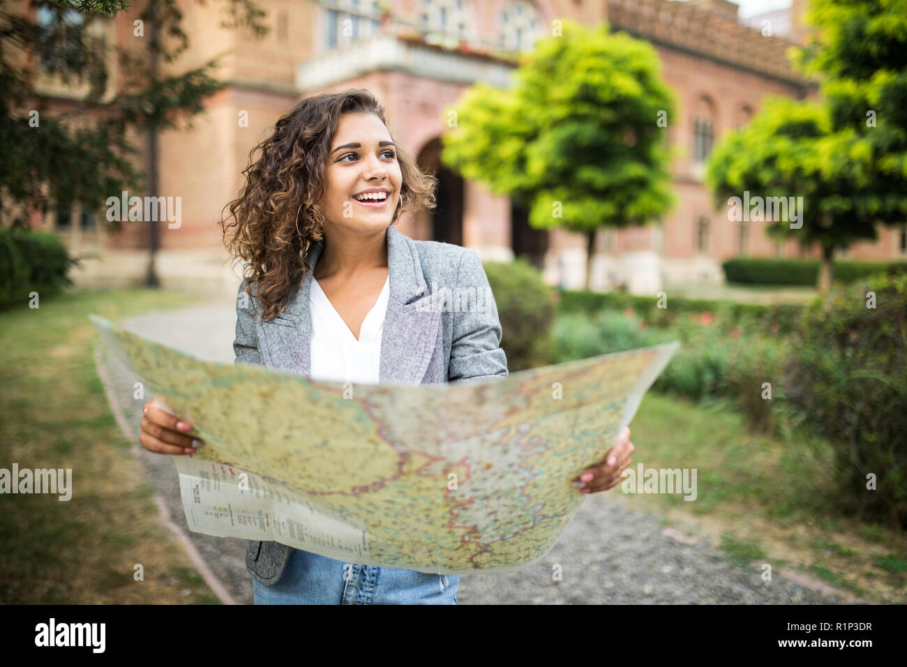 travel guide, tourism in Europe, woman tourist with map on the street ...