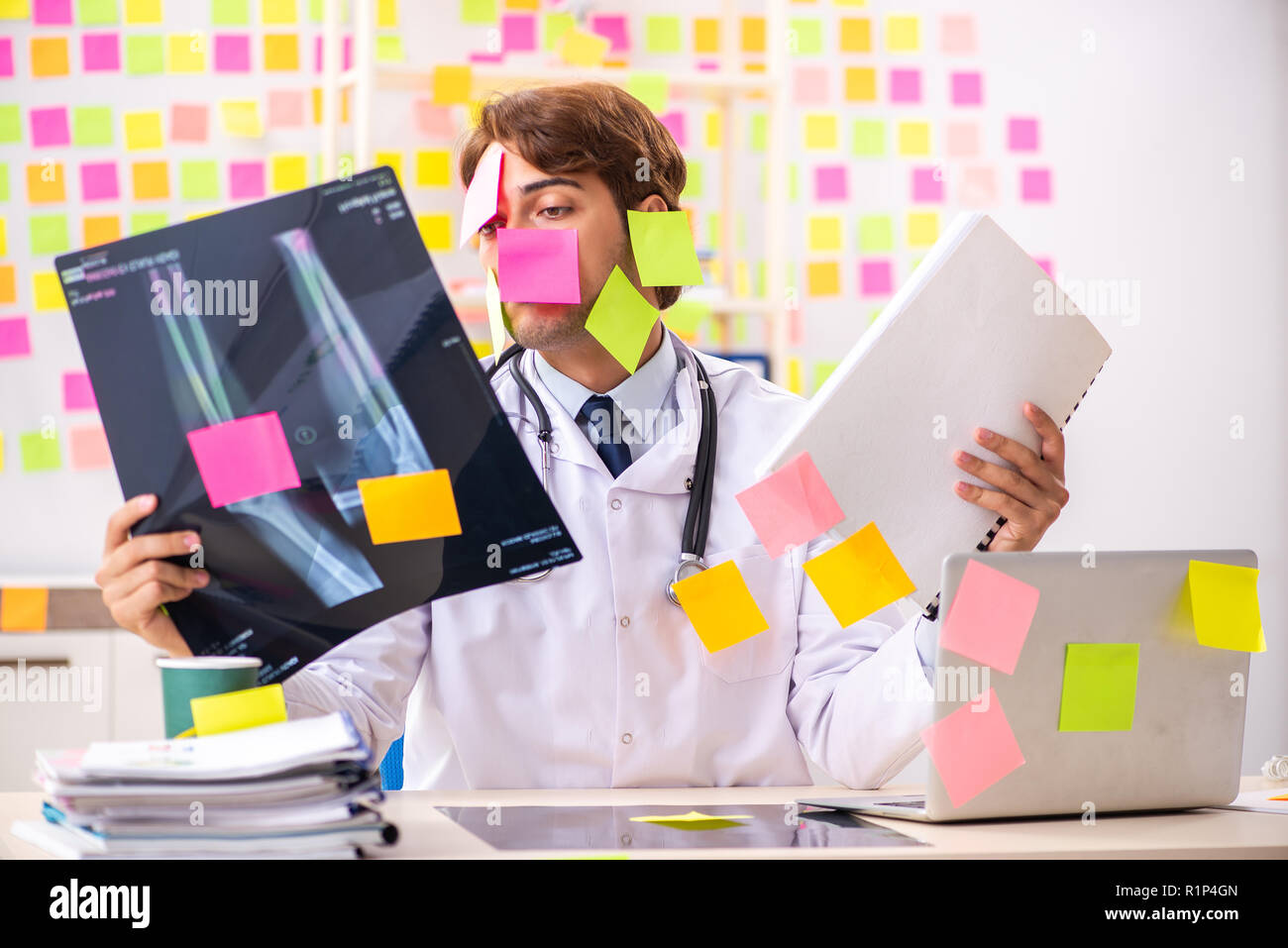Male doctor with many conflicting prioritites Stock Photo - Alamy