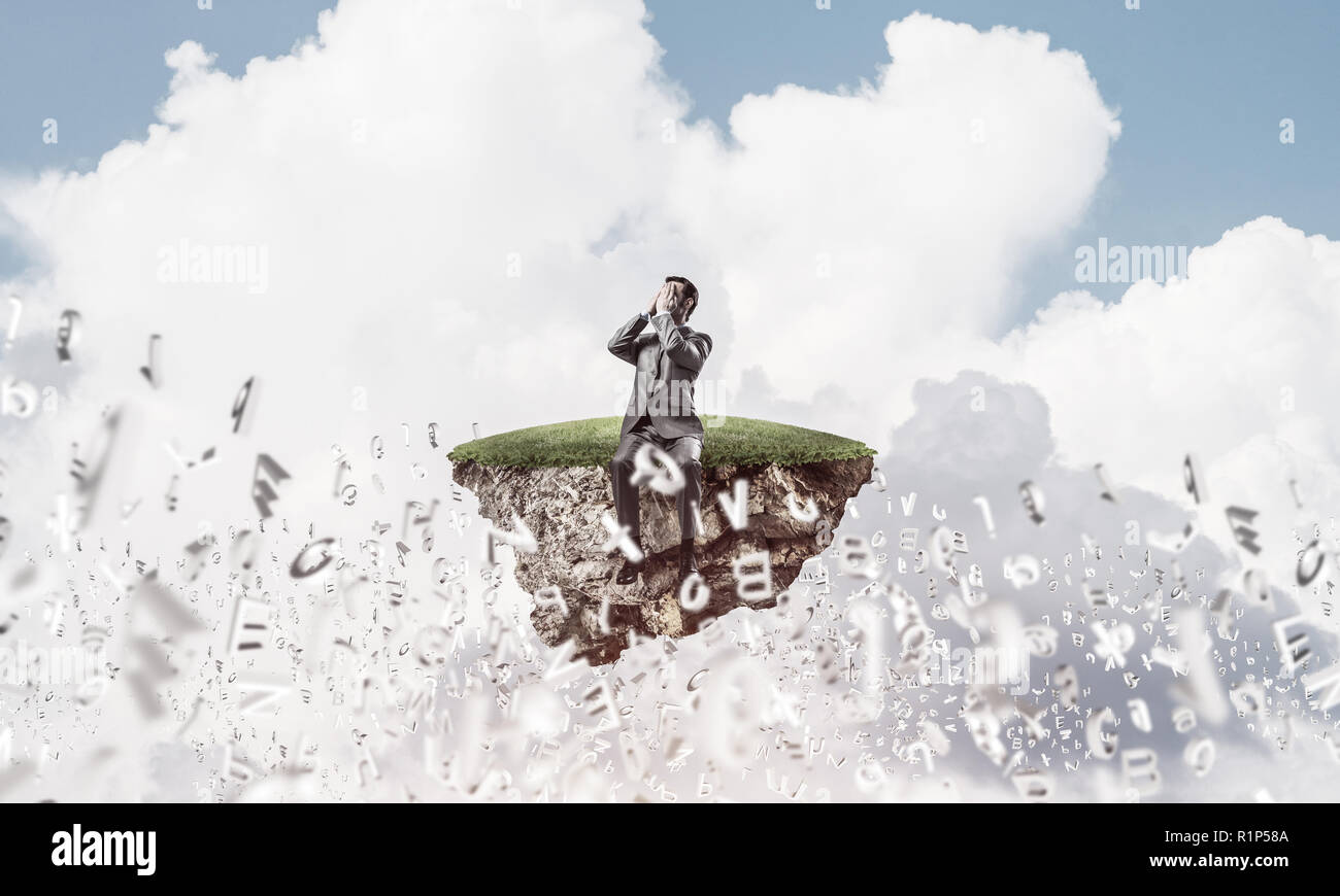 Young man floating in sky and do not want to see anything Stock Photo ...