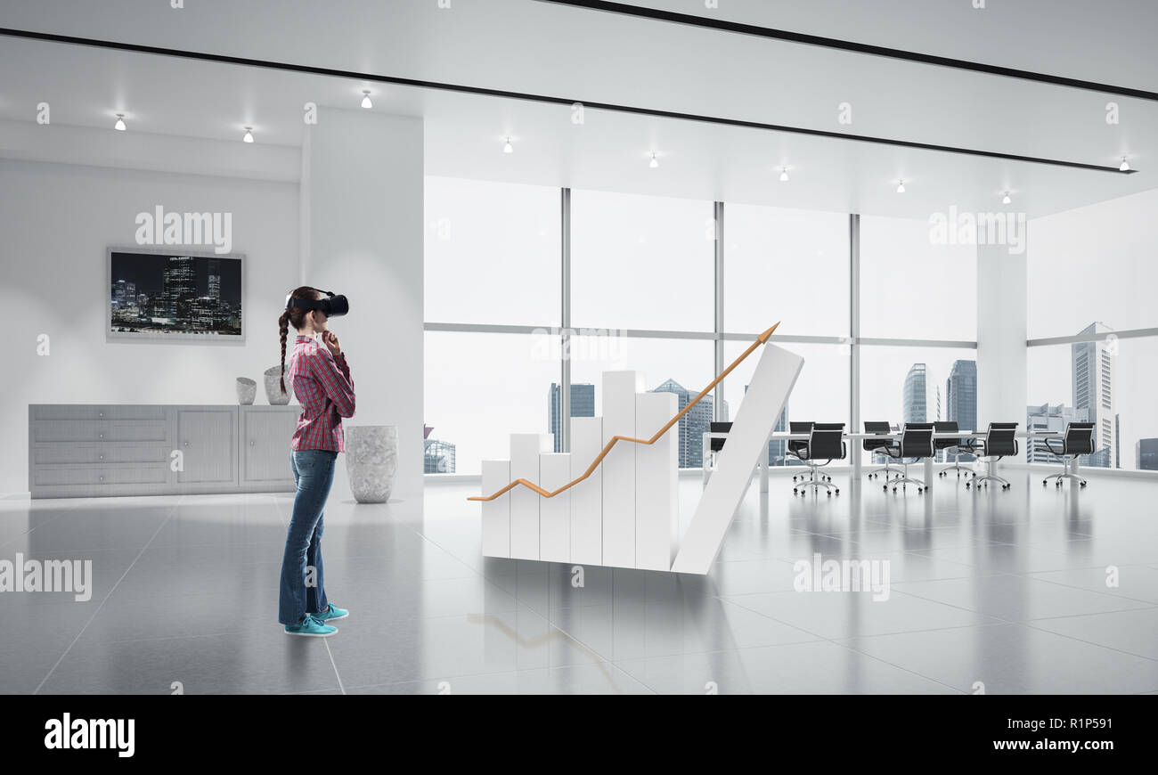 Girl in office interior in virtual reality mask using innovative Stock ...
