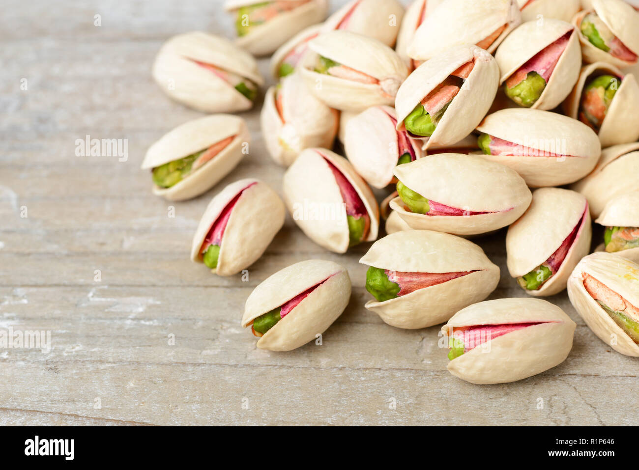 pistachio nuts with shell on the wooden table Stock Photo - Alamy