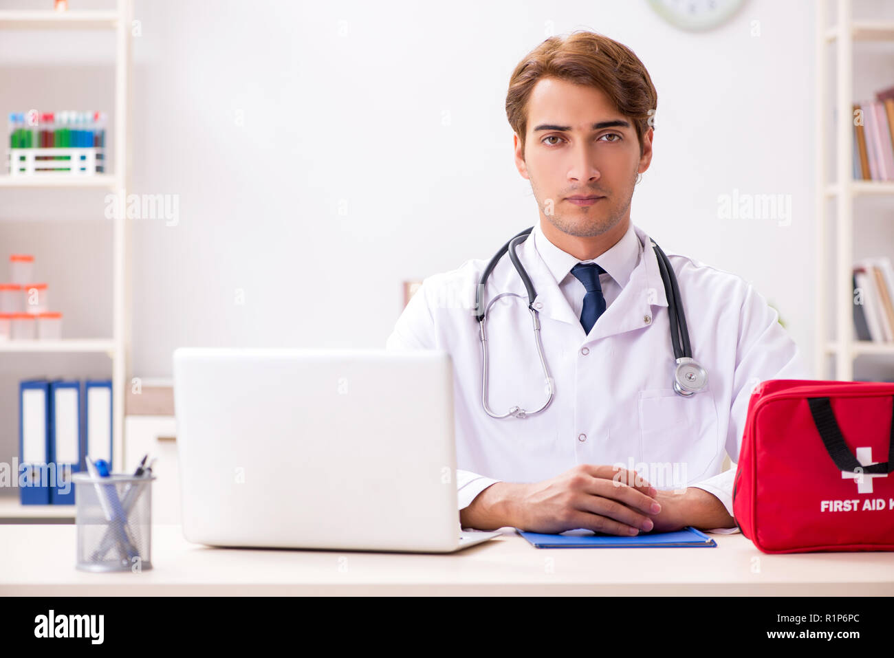 Young doctor with first aid kit in hospital Stock Photo - Alamy
