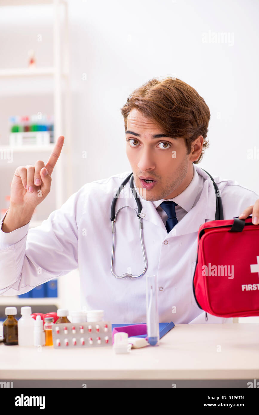 Young doctor with first aid kit in hospital Stock Photo - Alamy