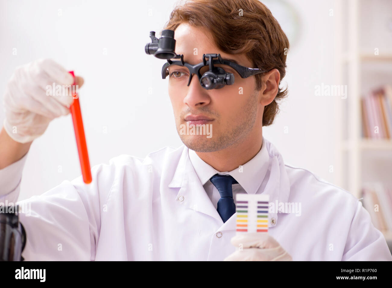 Chemist in the lab checking with ph strips Stock Photo - Alamy