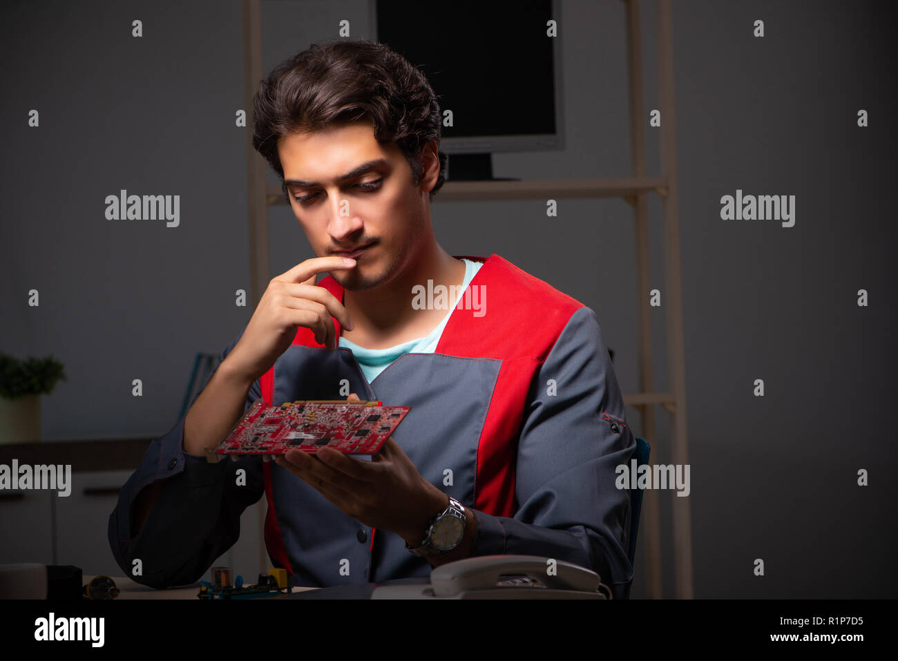 Young handsome repairman repairing computer Stock Photo - Alamy