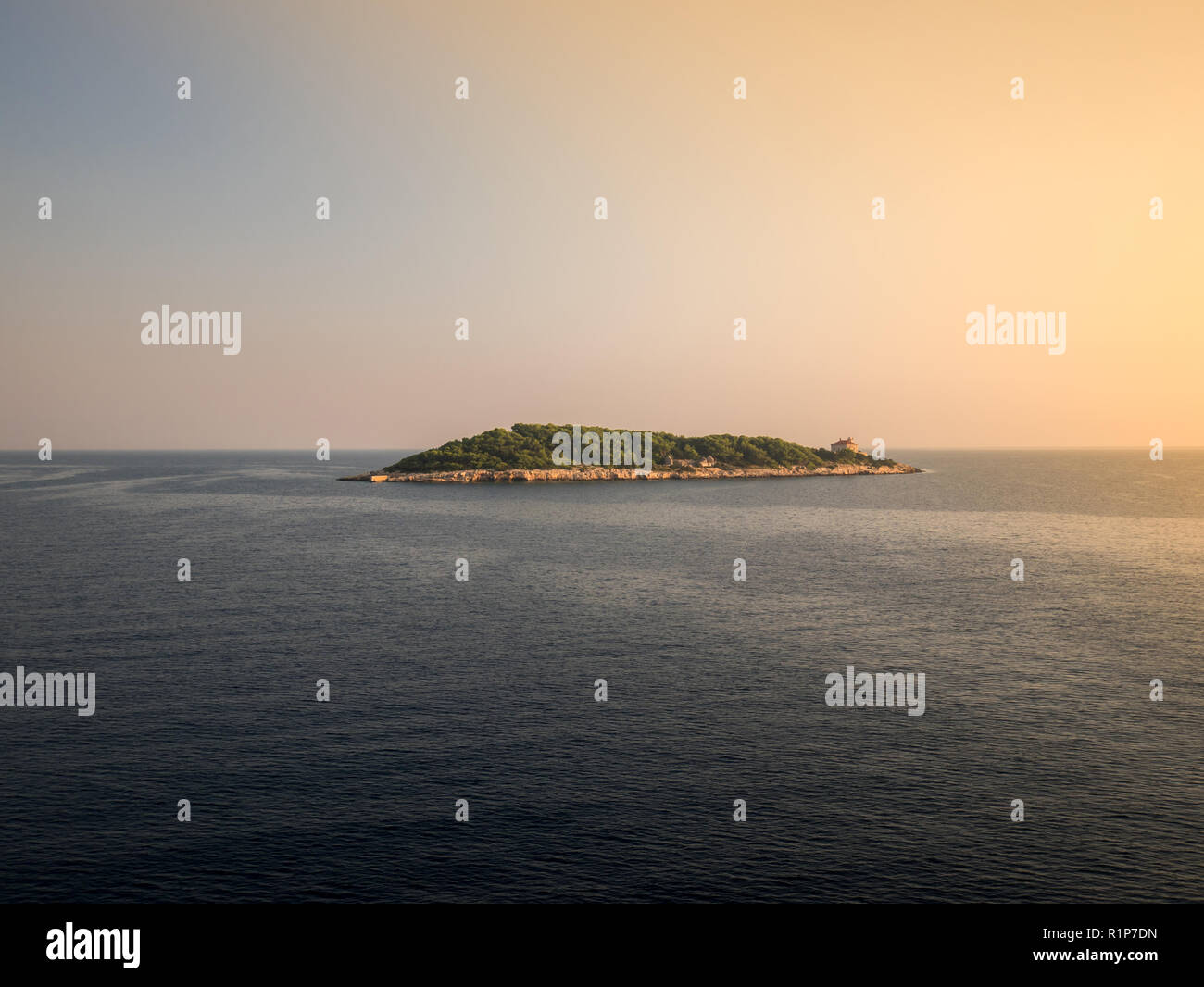 Small island Host in Croatia with lighthouse at sunrise Stock Photo - Alamy