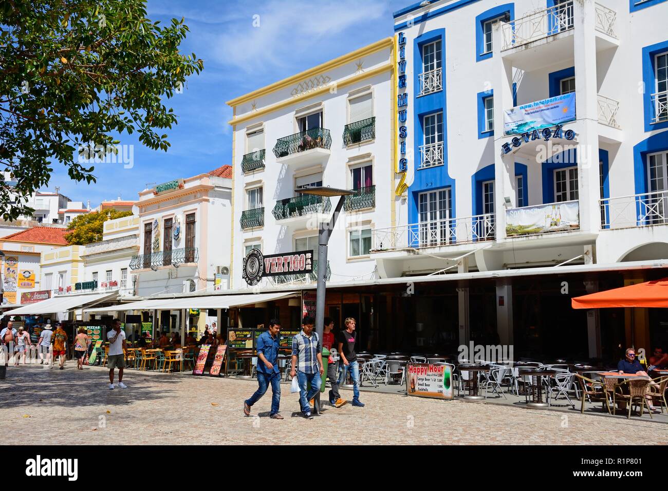 Pavement cafes in the main square in the old town with tourists passing ...