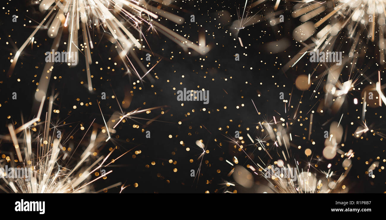 Burning christmas sparklers and smoke on dark background Stock Photo ...