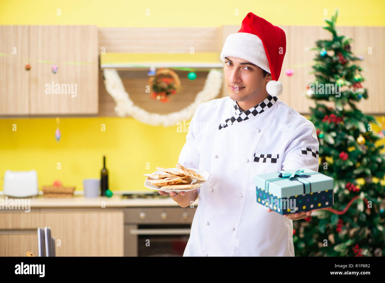 Young chef husband working in kitchen at Christmas eve Stock Photo - Alamy