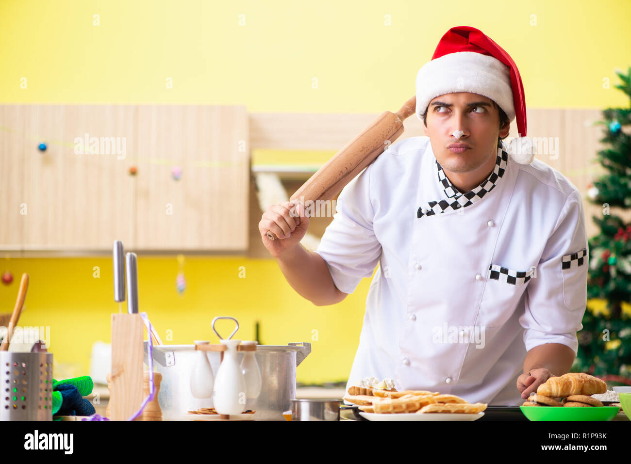 Young chef husband working in kitchen at Christmas eve Stock Photo - Alamy